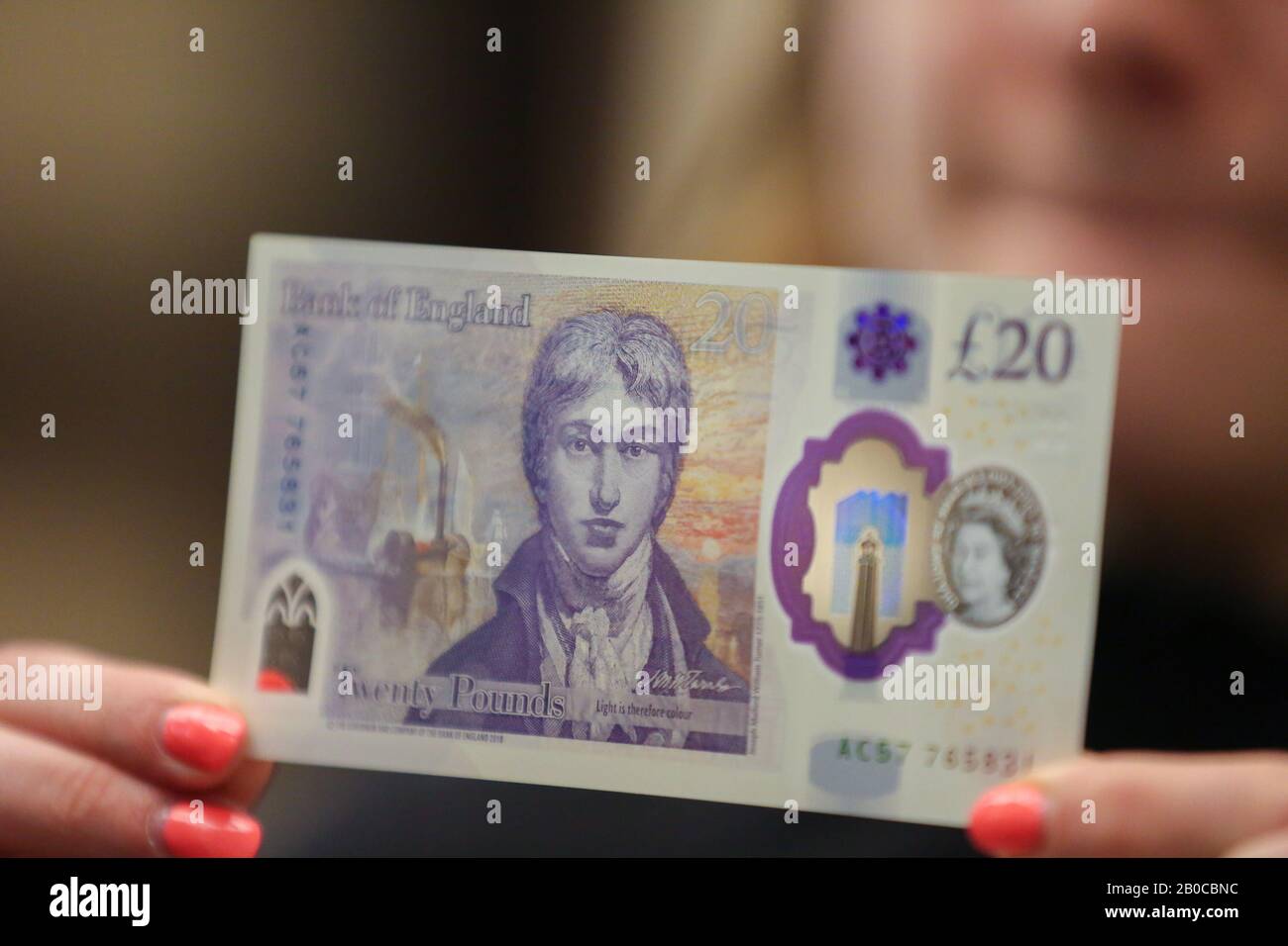Tate Britain, London, UK 20 Feb 2020 - A staff member holds the new £20 ...