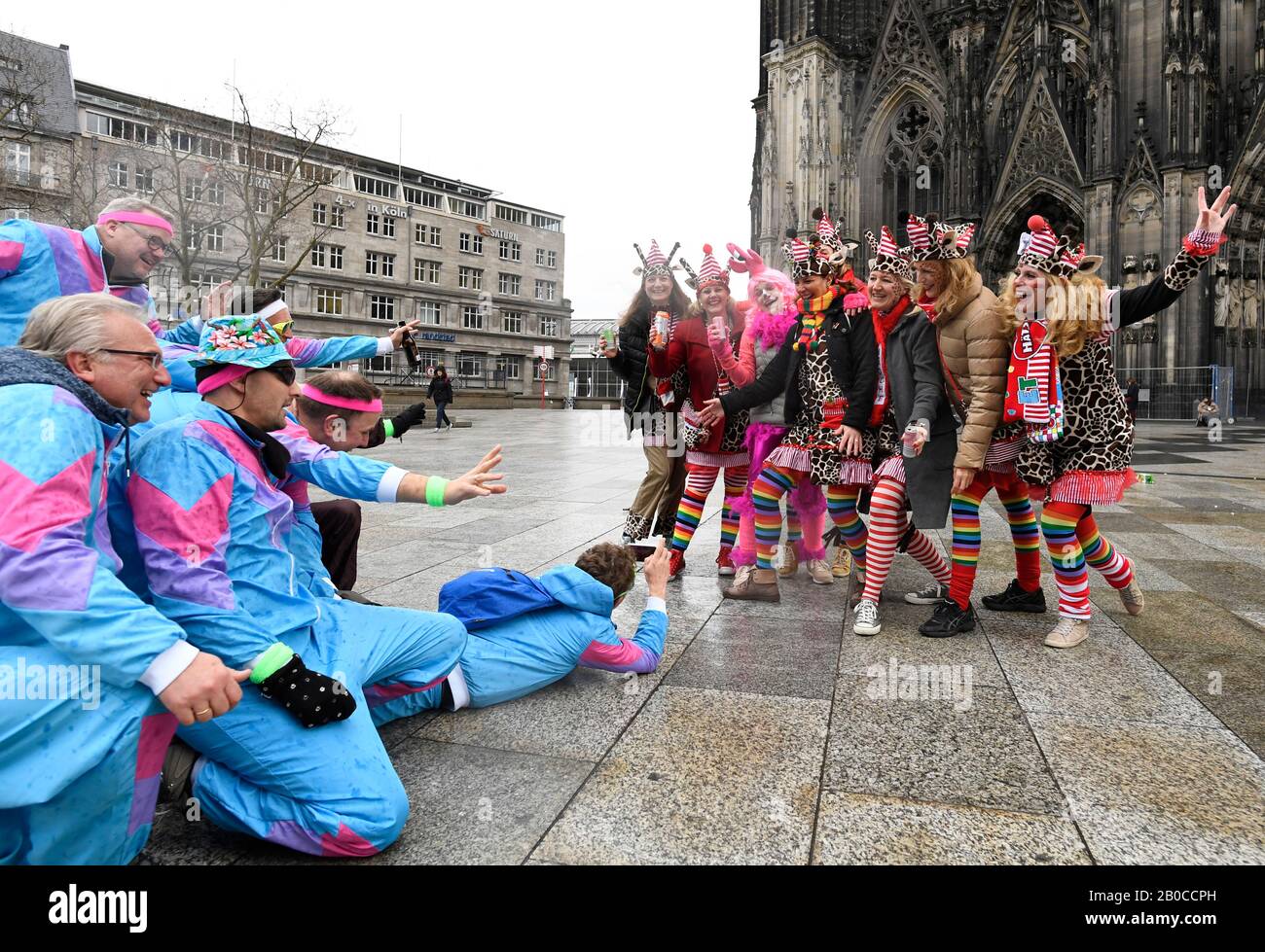 Cologne, Germany. 20th Feb, 2020. A group of dressed up men take ...