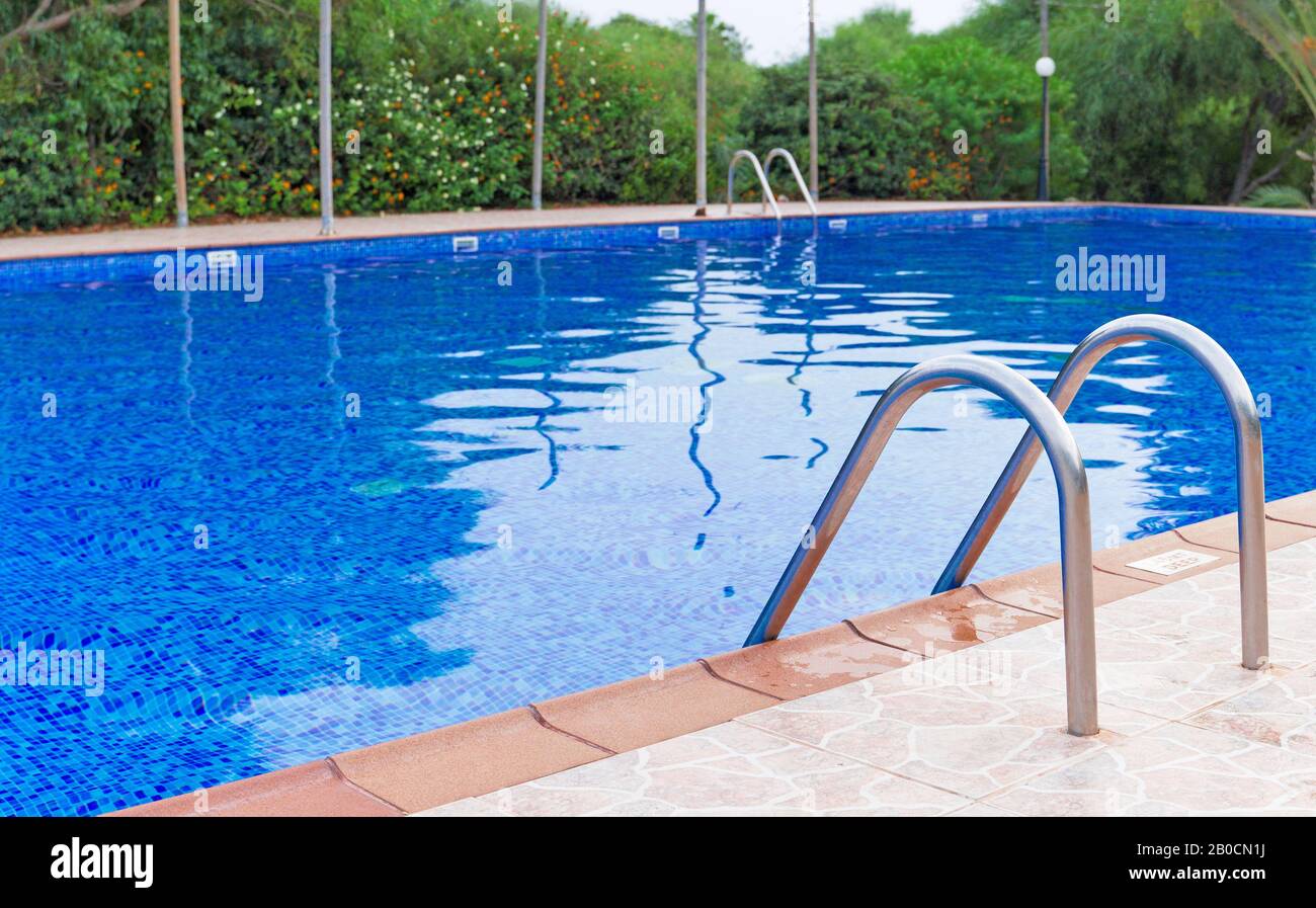 Outdoor swimming pool at summer time Stock Photo - Alamy