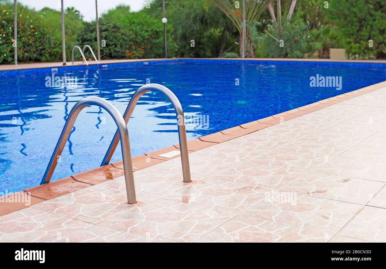 Outdoor swimming pool at summer time Stock Photo - Alamy
