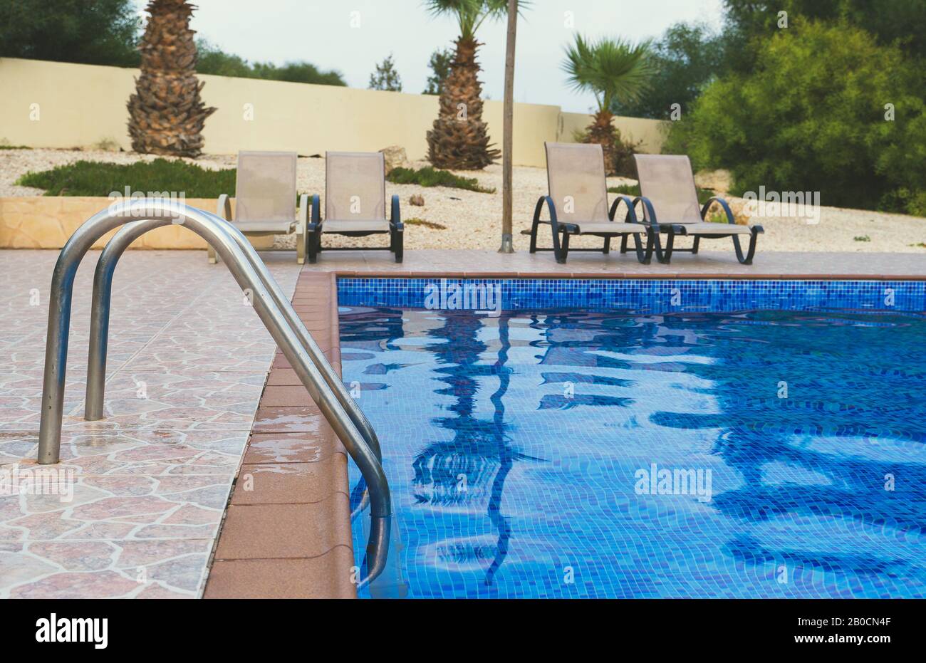 Outdoor swimming pool at summer time Stock Photo - Alamy