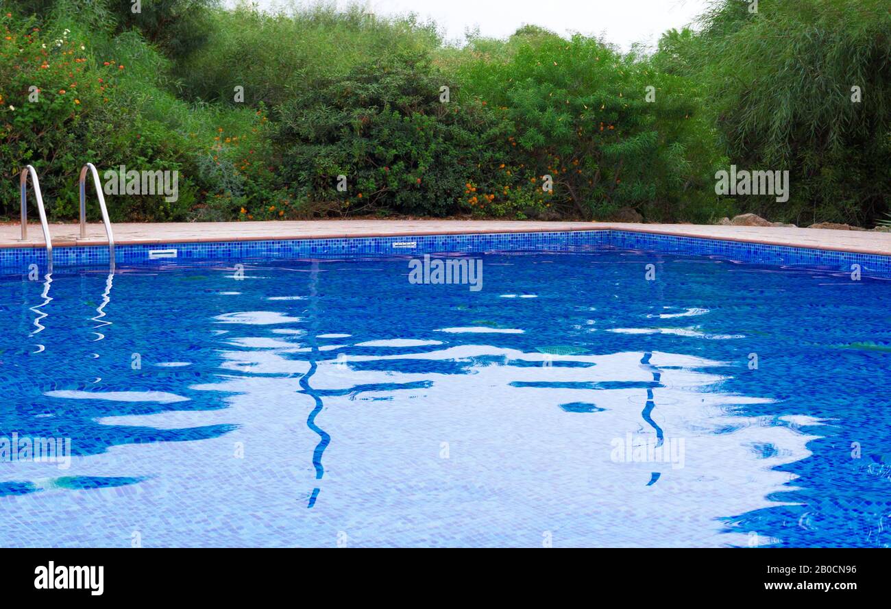 Outdoor swimming pool at summer time Stock Photo - Alamy