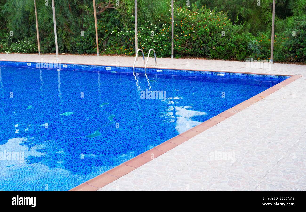 Outdoor swimming pool at summer time Stock Photo - Alamy