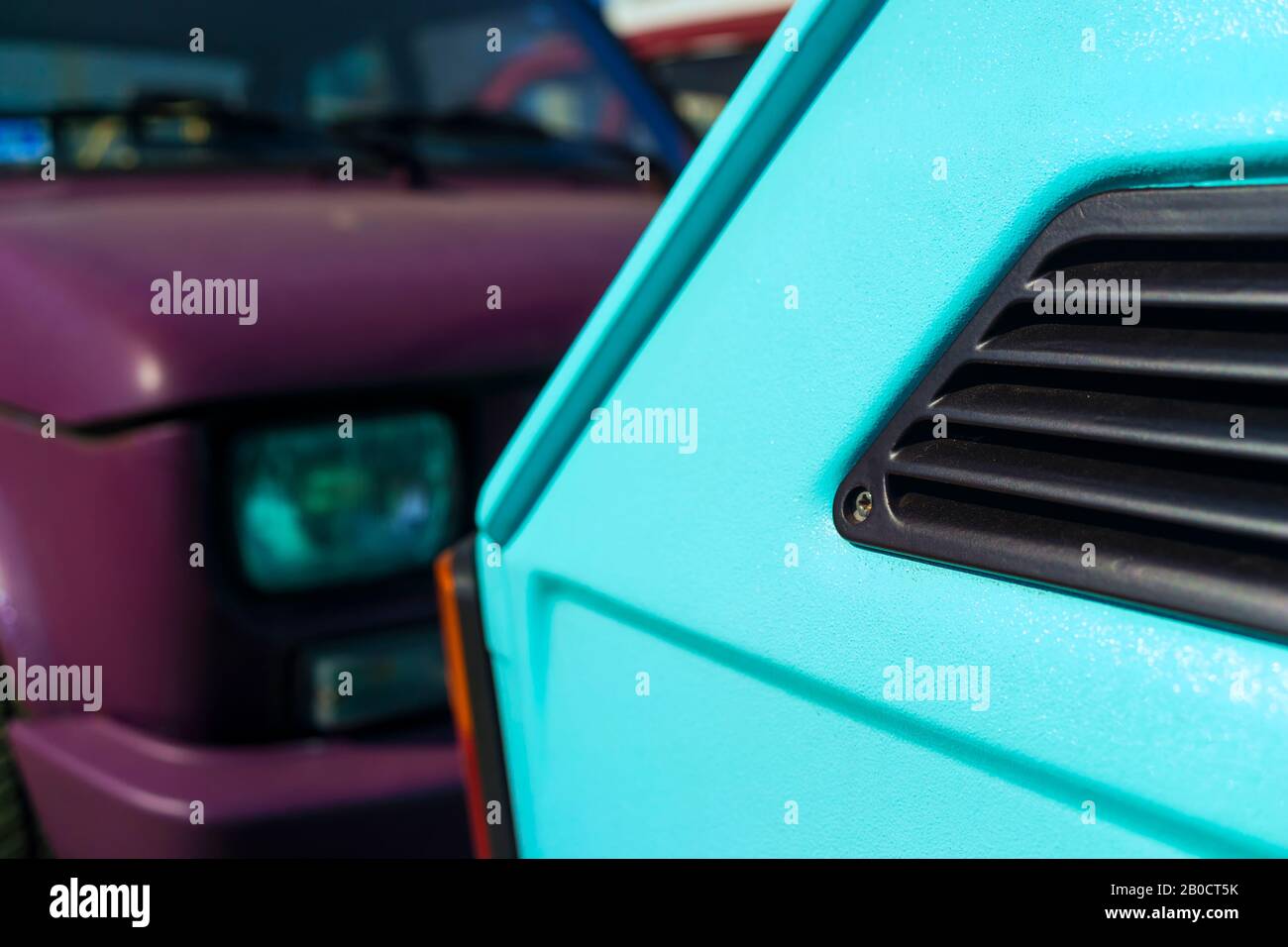Two small cars of different colors on the road Stock Photo - Alamy