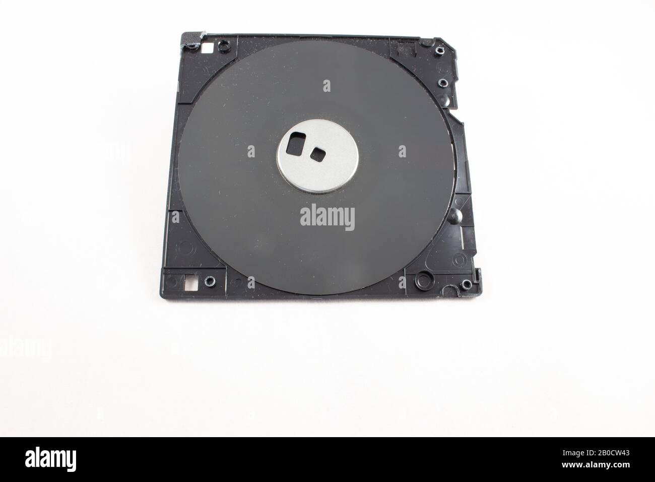 Open old floppy disc showing the magnetic data carrier inside on white ... Open old floppy disc showing the magnetic data carrier inside on white ...