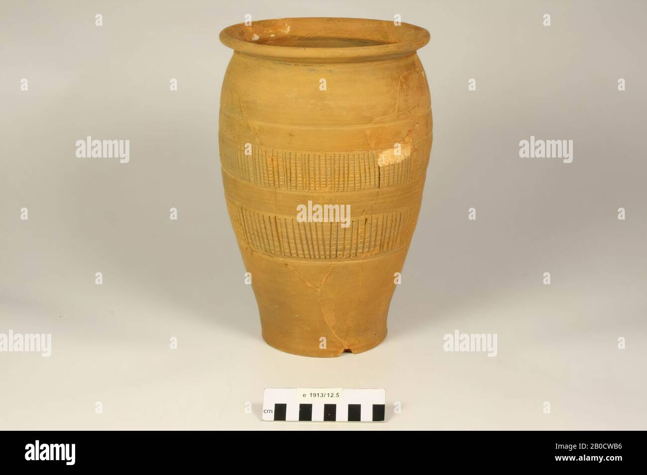 High cylindrical urn of smooth-walled earthenware with notched ...