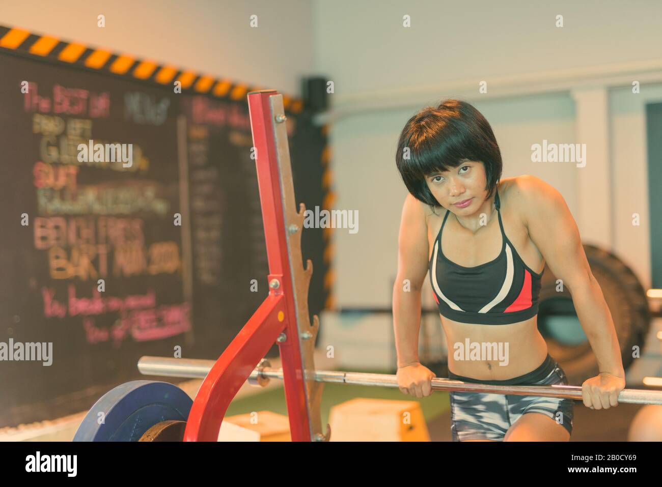 Young beautiful Asian woman working out at the gym Stock Photo - Alamy