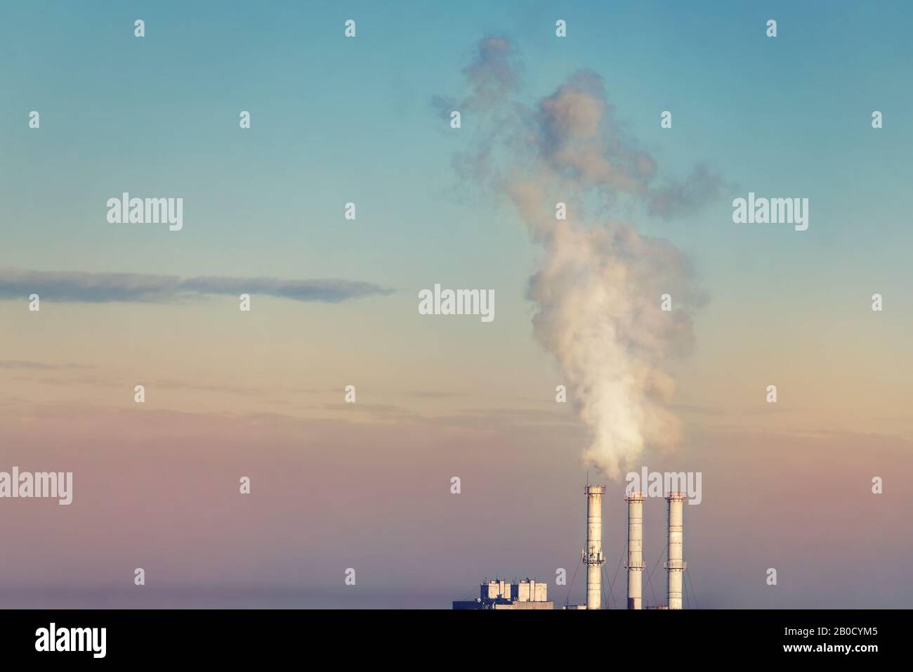 Three smoking stack pipes making clouds of white smoke with dramatic ...