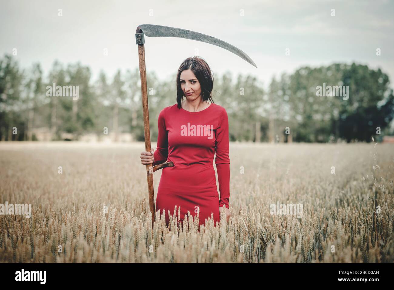 Young Woman with scythe in the forest outdoor Stock Photo - Alamy