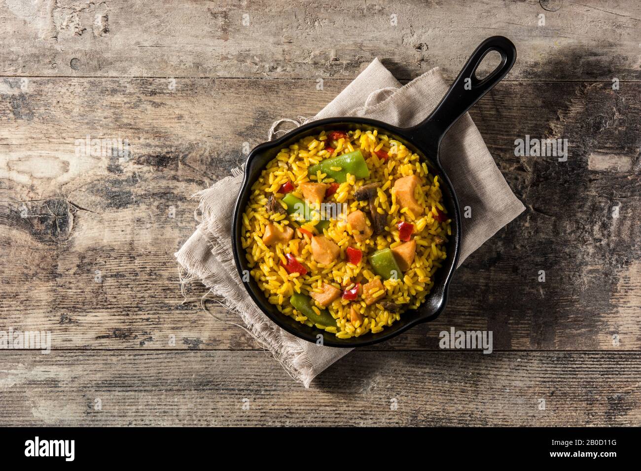 Fried rice with chicken and vegetables on frying iron pan. Top view ...