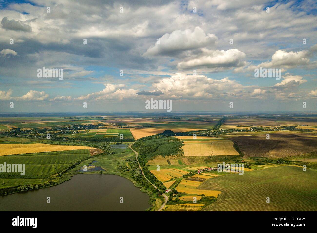 Aerial rural landscape with yellow patched agriculture fields and blue ...