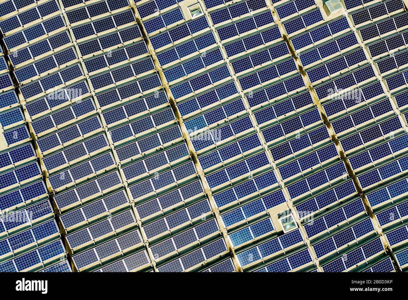 Aerial view of many photo voltaic solar panels mounted of industrial ...