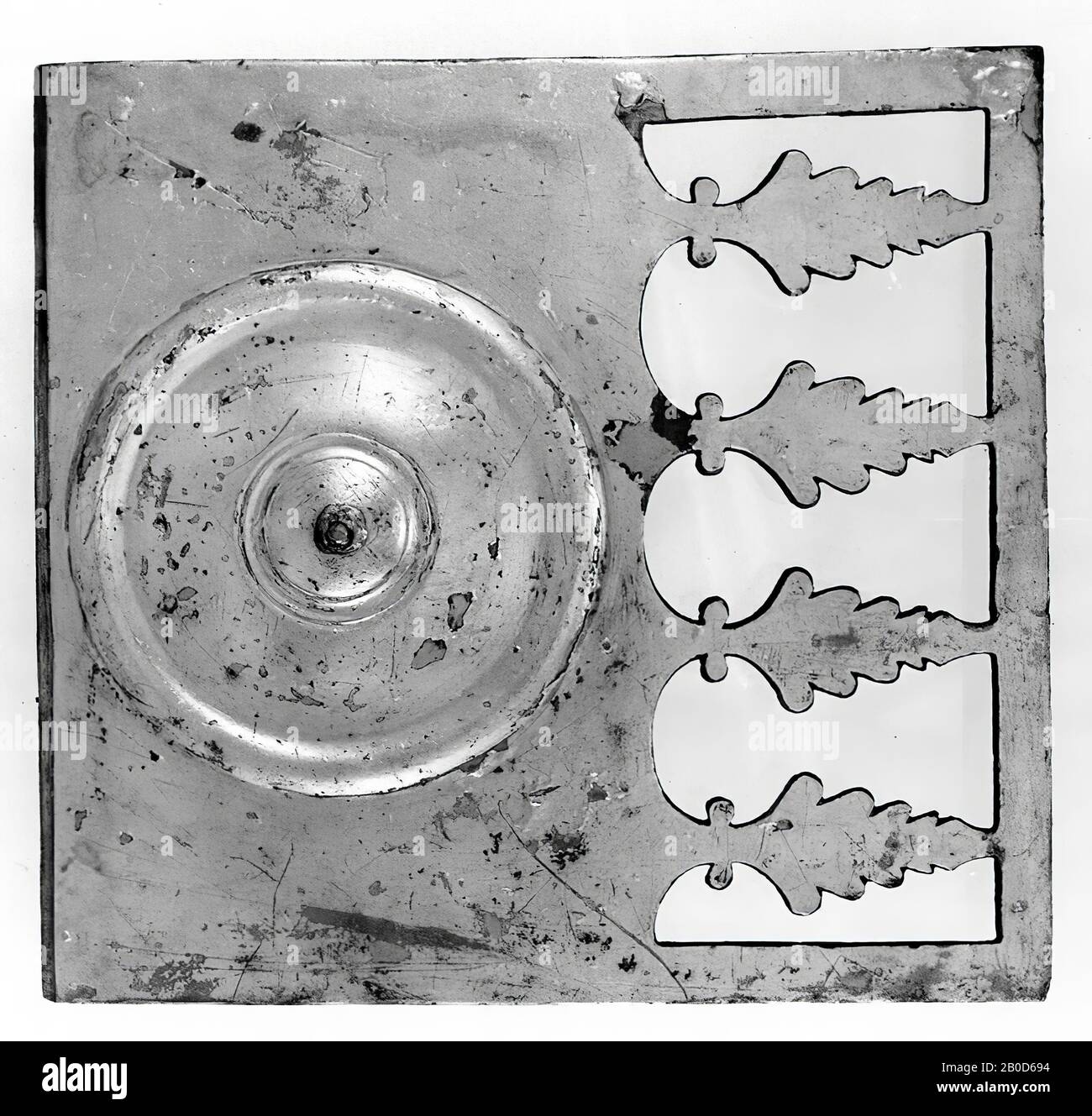 Rectangular plate of silver-plated bronze. At the top a circular motif ...