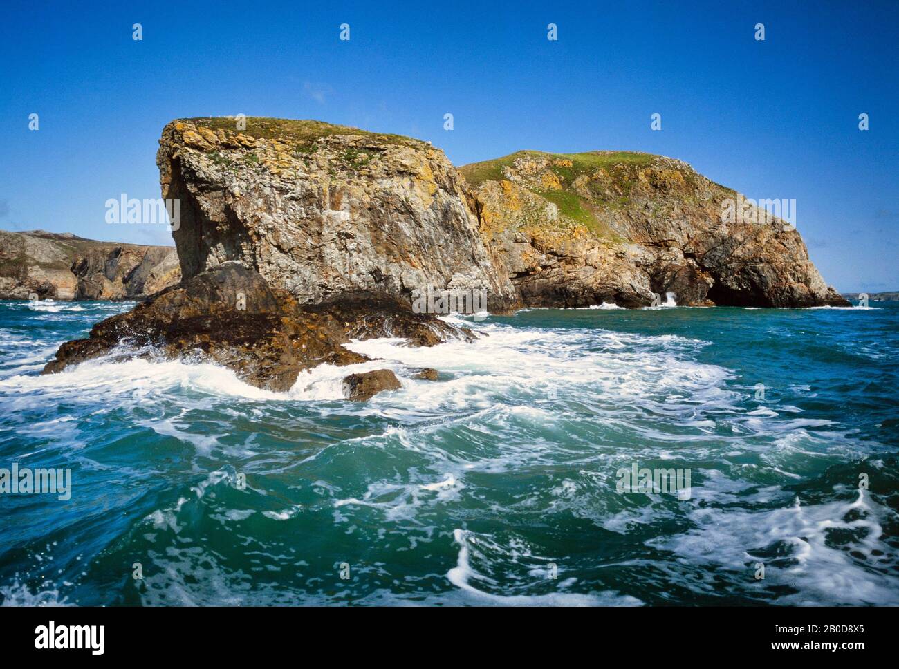 Coastal scenery viewed from offshore, sheer cliffs around Ramsey Island ...