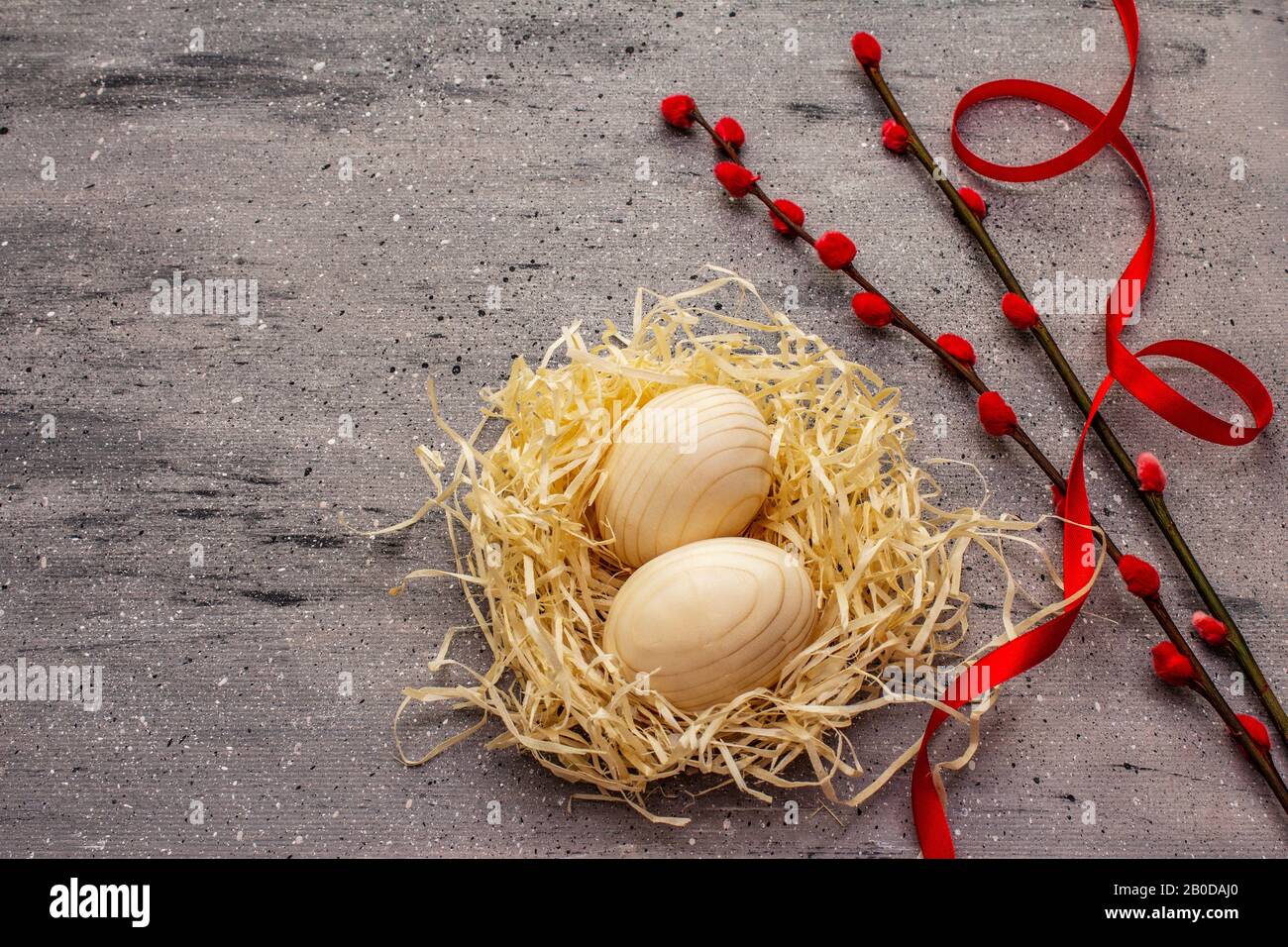 Zero waste Easter concept. Wooden egg, bird's nest, satin ribbon, red ...