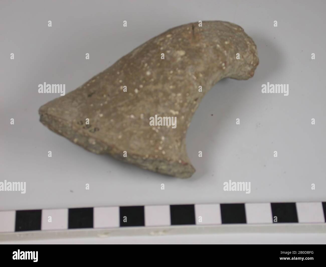 Fragment of a handle. An oblique cross (X) is notched on the outside of ...