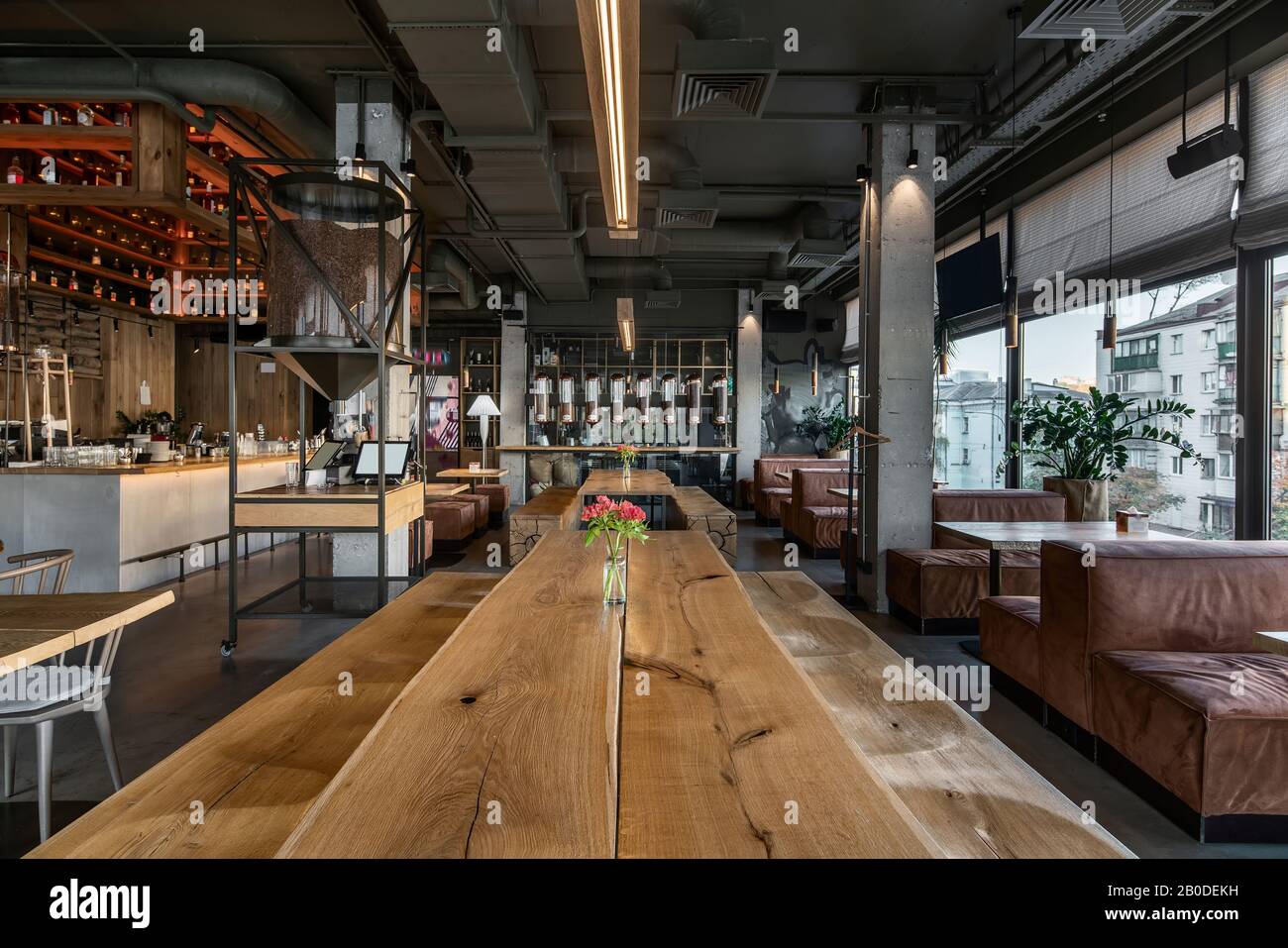 Stylish coffee house in a loft style with big panoramic windows and ...