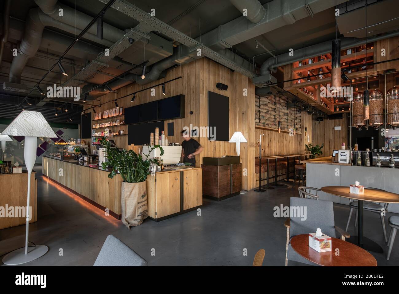 Restaurant in loft style with textured wooden walls. There are tables ...