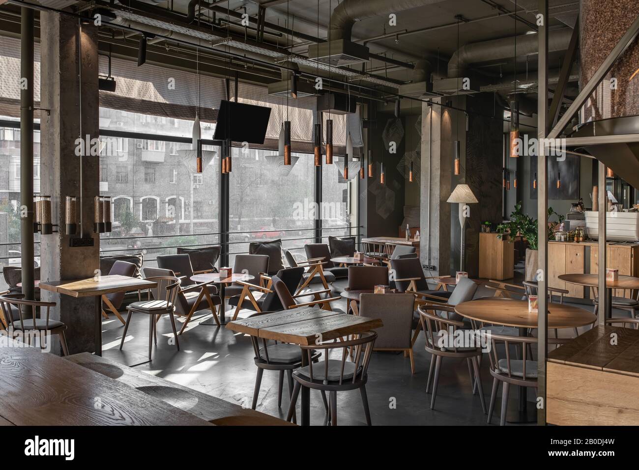 Nice coffee house in loft style with big panoramic windows and concrete ...