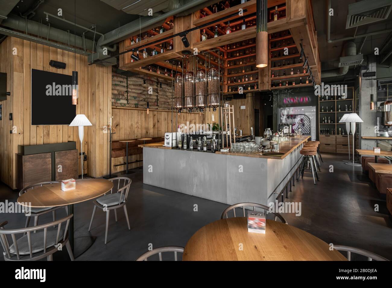 Cafe in a loft style with textured wooden walls and concrete columns ...
