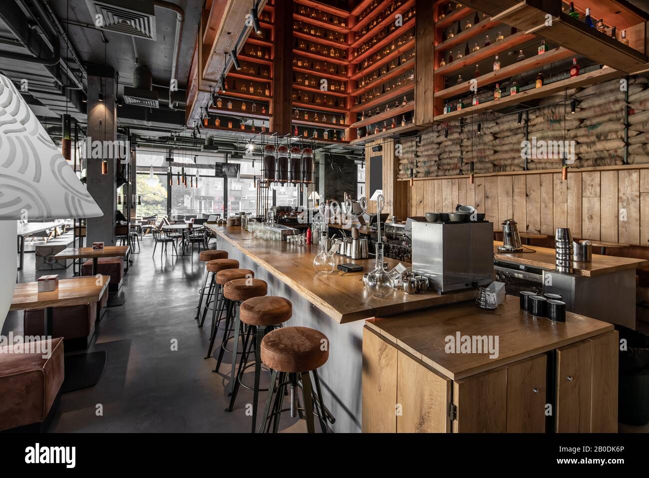 Restaurant in loft style with big panoramic windows and concrete ...