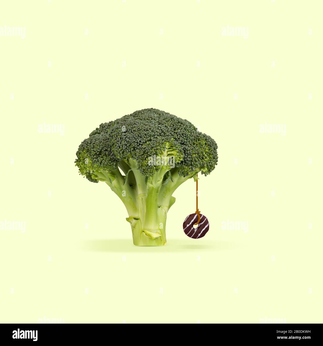 Food world. Broccoli as a tree with wheel-swing as a chocolate donut on ...