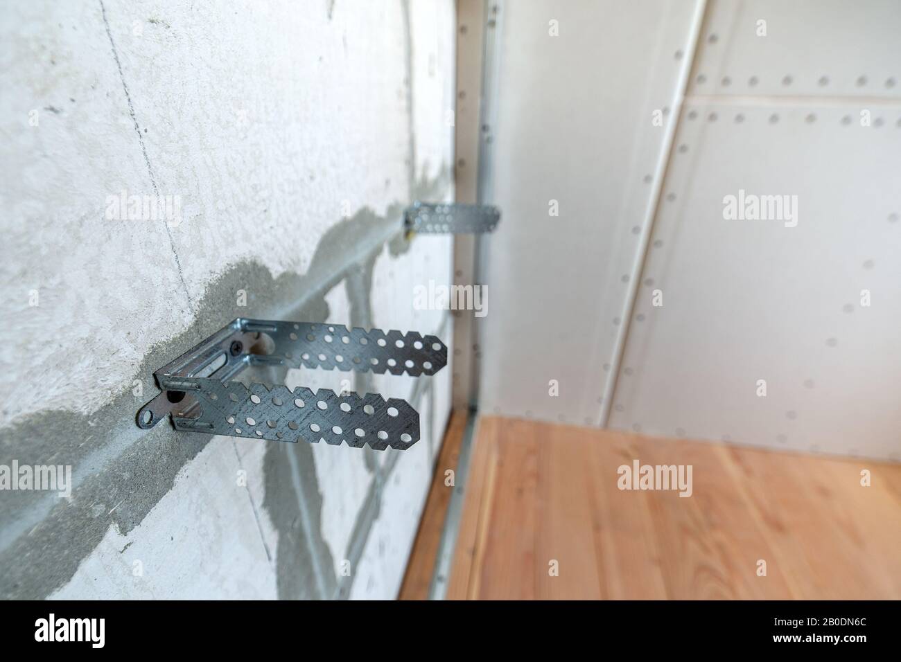 Unfinished brick wall in a room under construction prepared for drywall ...