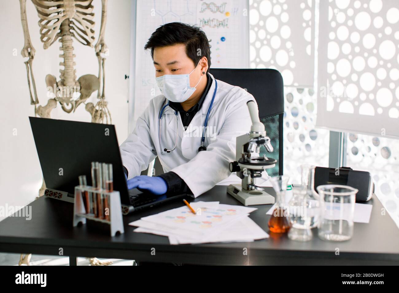 Asian researcher on microscope hi-res stock photography and images - Alamy