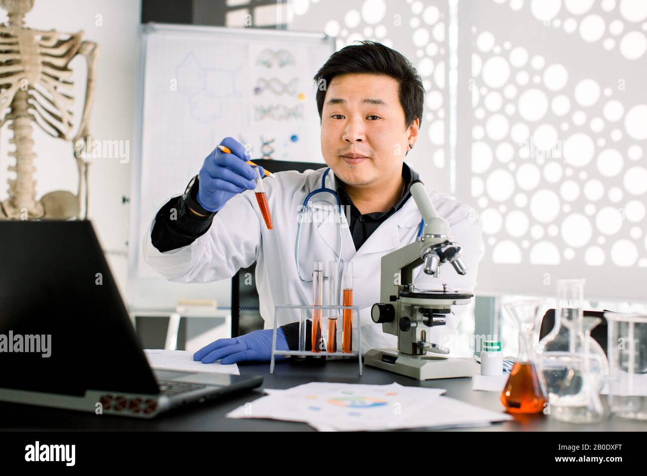 Asian Korean male doctor biochemist scientist in white coat and ...