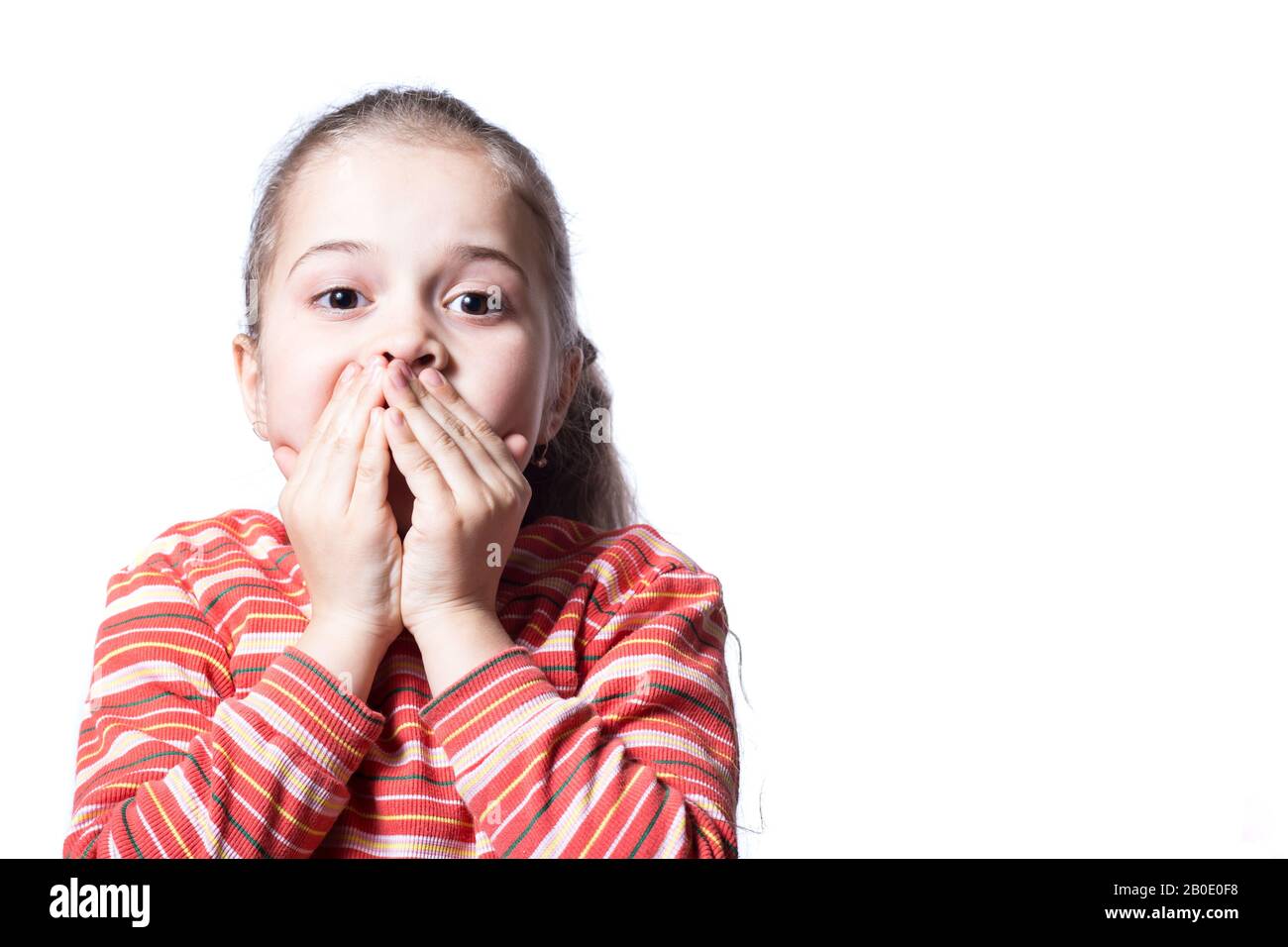 the girl covered her mouth with her hands. baby in shock. Child is ...