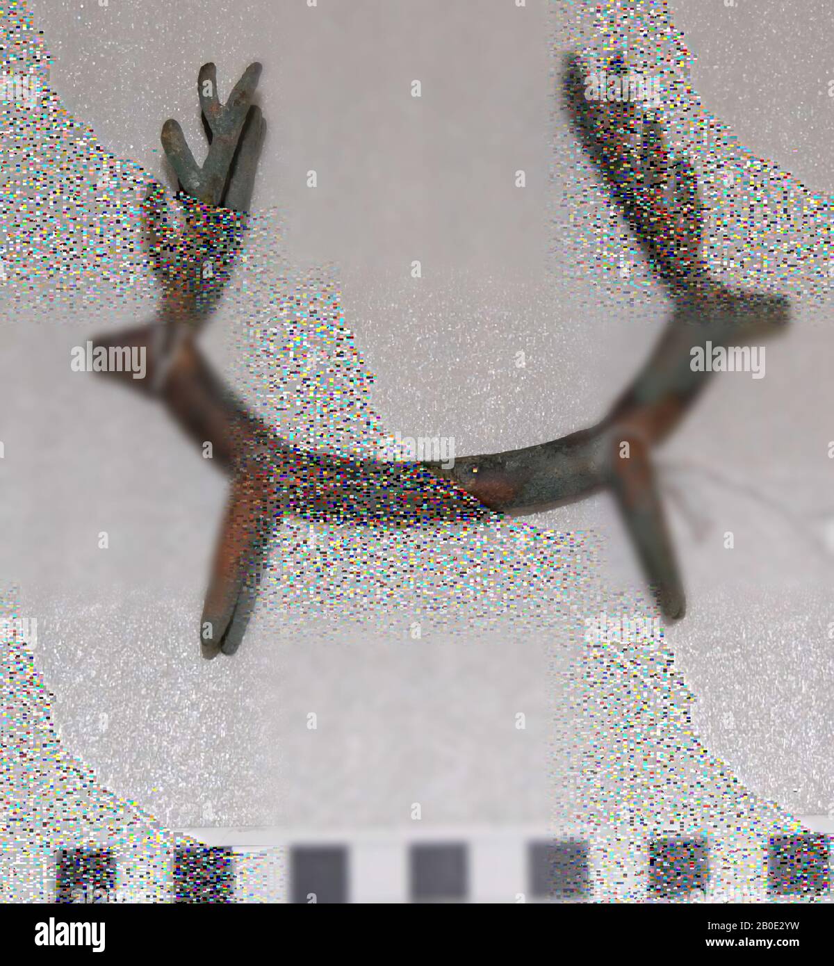 A bronze figurine in the shape of a double deer with huge antlers ...