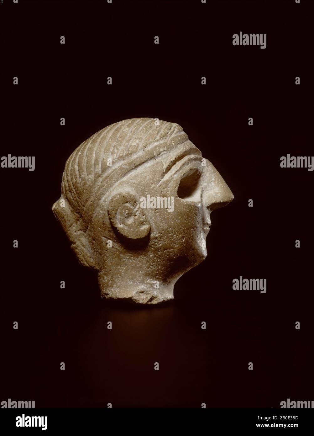A woman's head of a cream-colored limestone, with a pointy nose. The ...