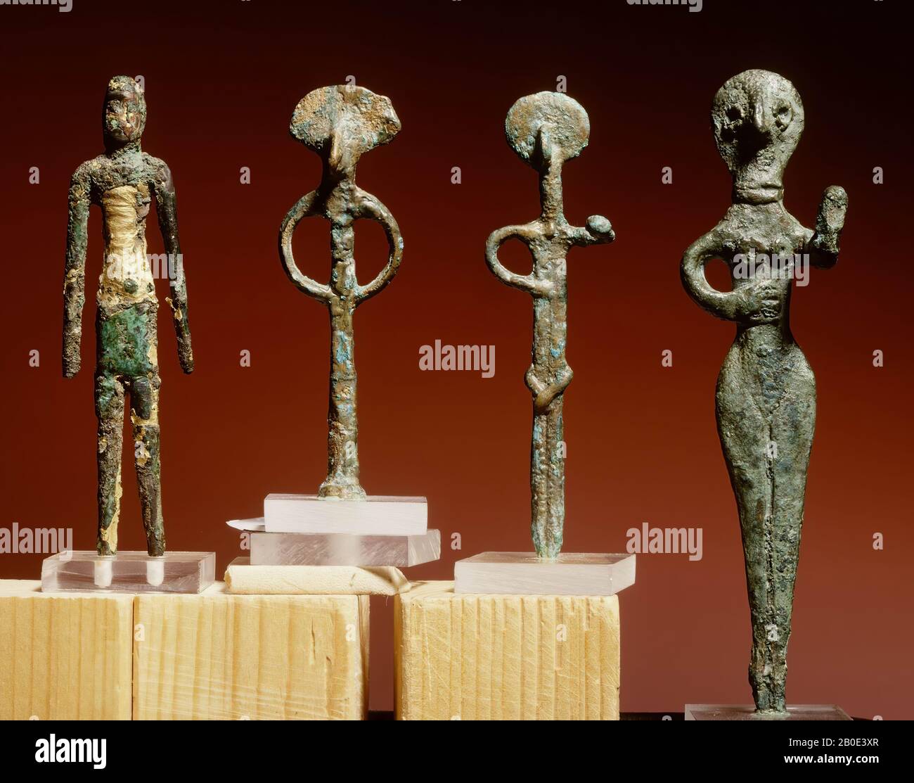 A stylized bronze statue of a human figure. The legs end at the bottom ...