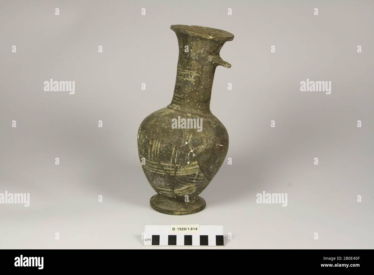 An earthenware jug with a foot. The long straight neck is skewed on the ...