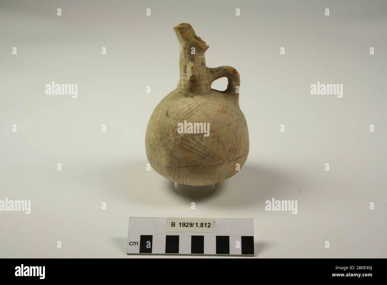 An earthenware can with a pronounced spout, one ear and round bottom ...