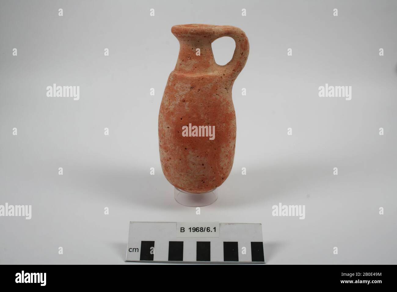 A complete jug with one ear and an outwardly extending rim. The soil is ...