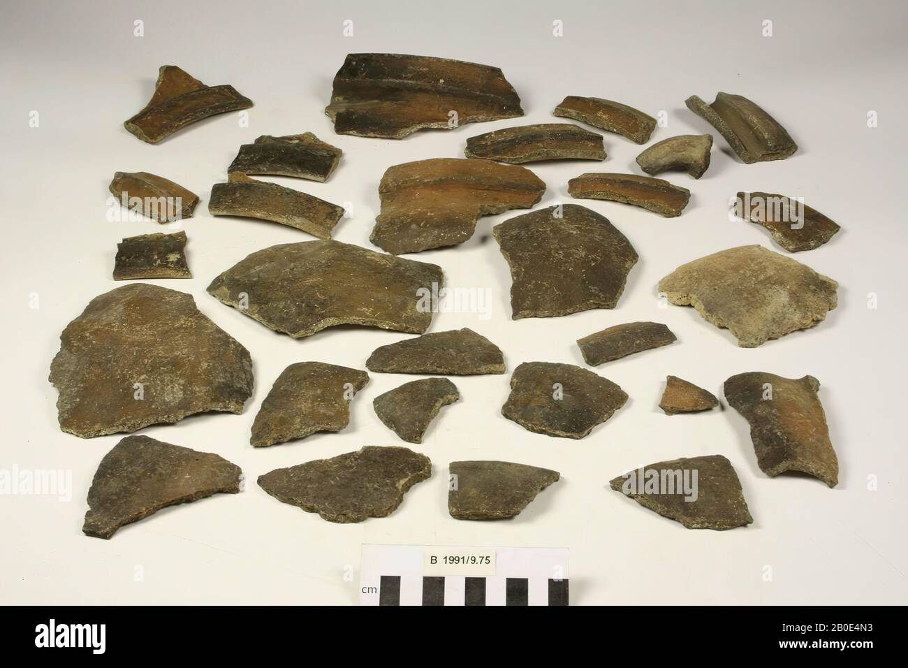 Loose shards belonging to a cooking pot of baked clay. The cooking pot ...