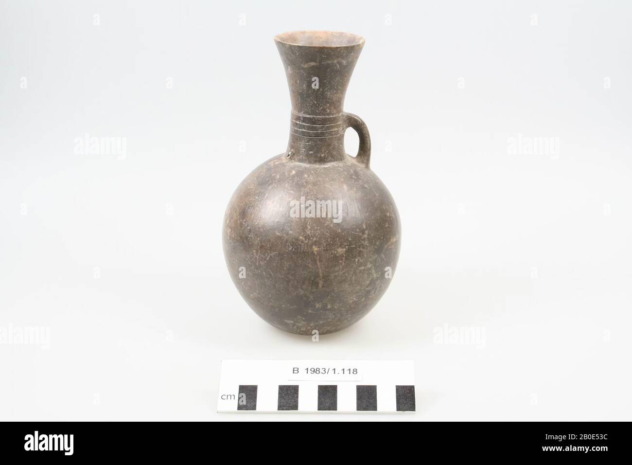 A thick-walled jug with a flared long neck and one ear. The neck is ...