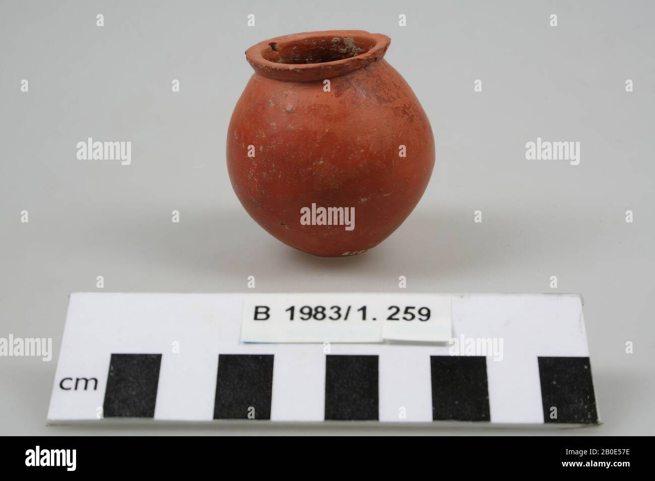 An earthenware pot or jug with a rounded body and a round bottom. The ...