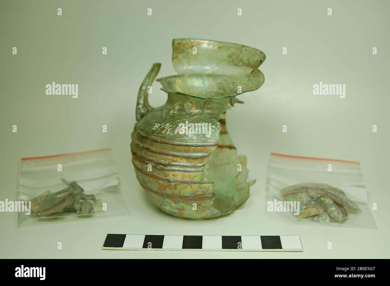 Spherical pot of light green glass, with short neck and wide mouth. The ...