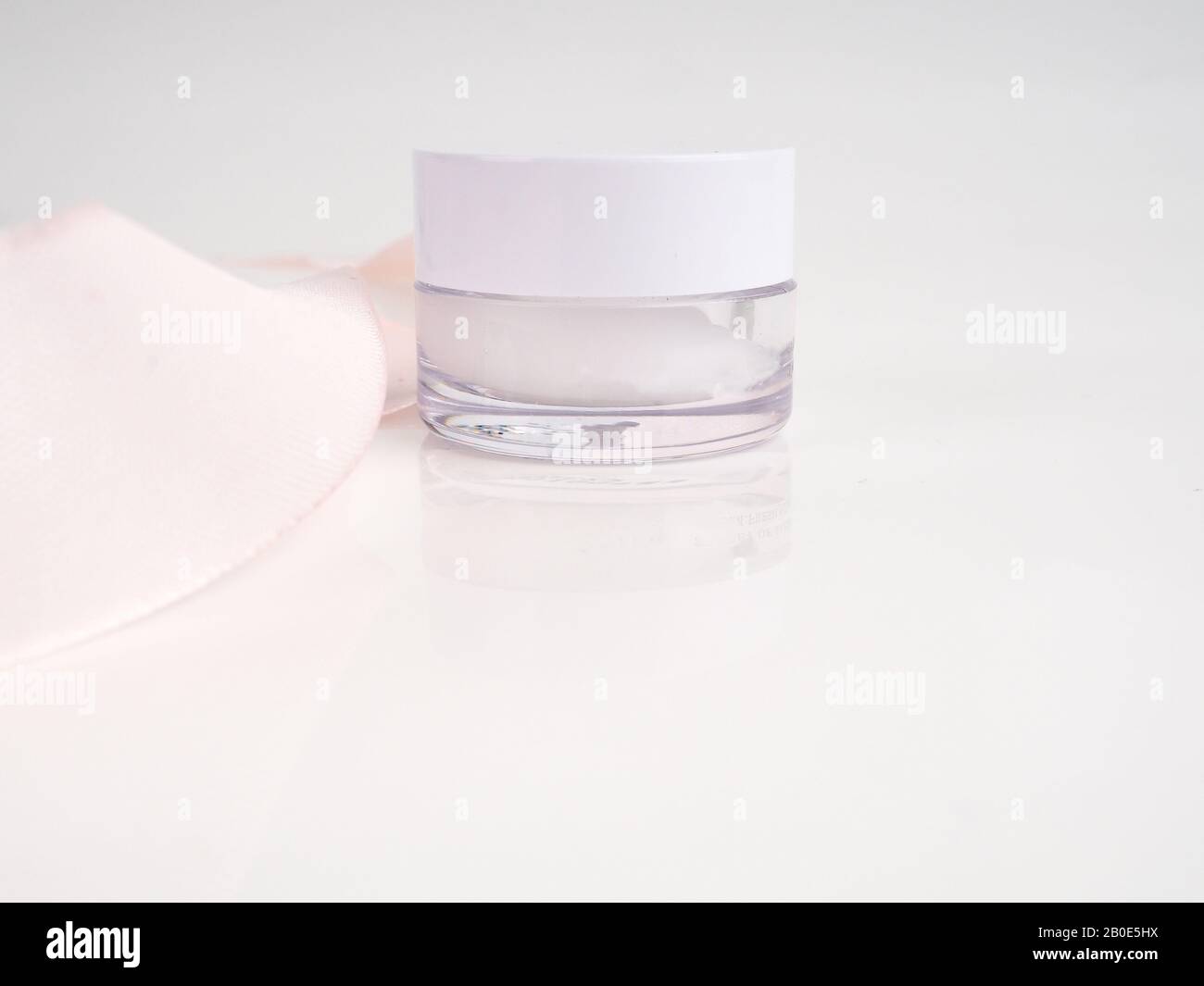 Container of moisturizing face cream on white background. Fashion woman ...