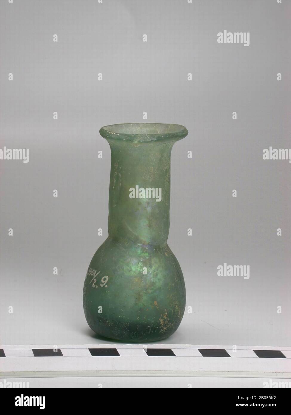 Spherical bottle of teal glass with long neckline and flat mouth rim ...