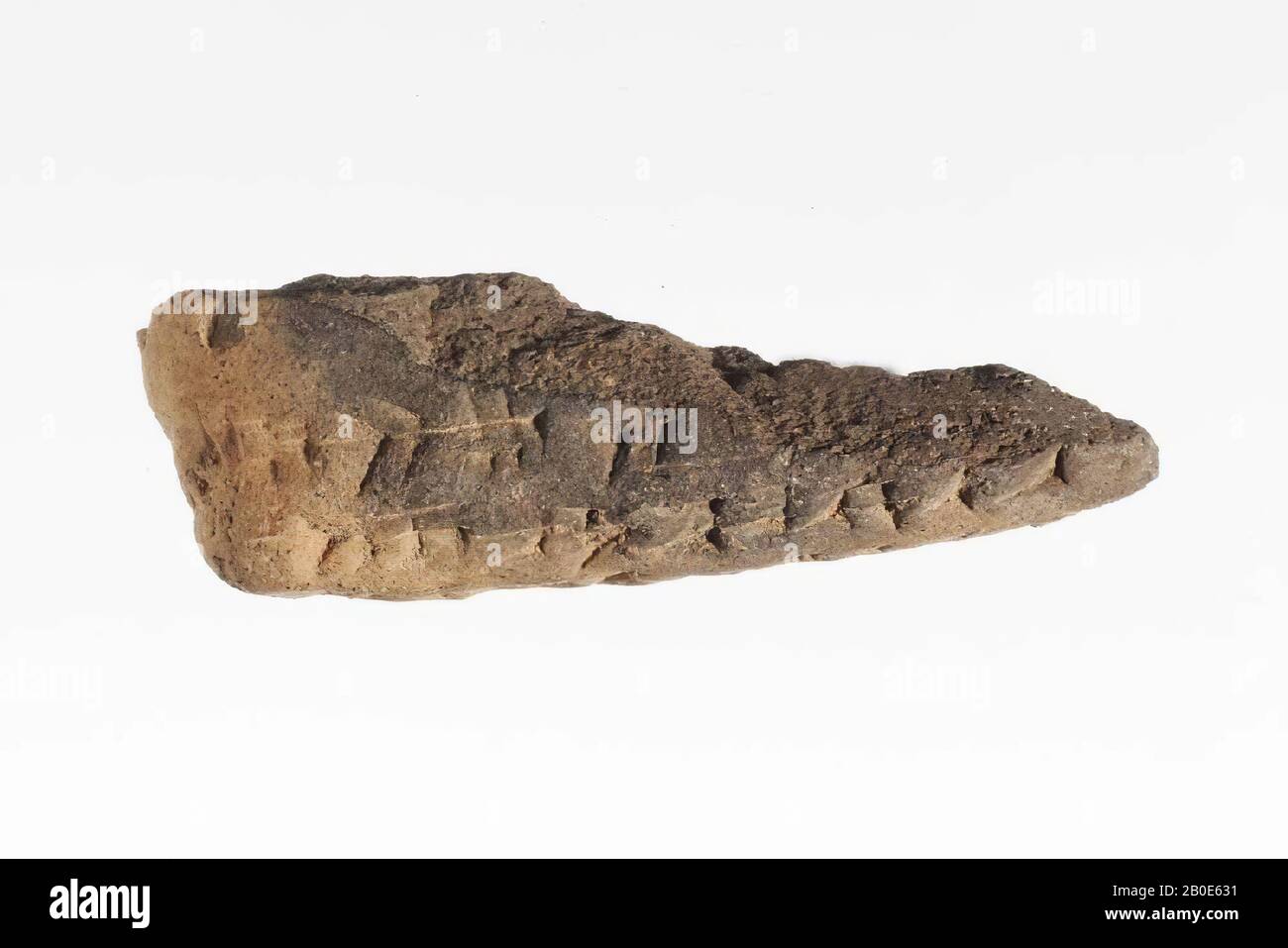 A fragment of a clay tablet with cuneiform writing. The text has 5 ...