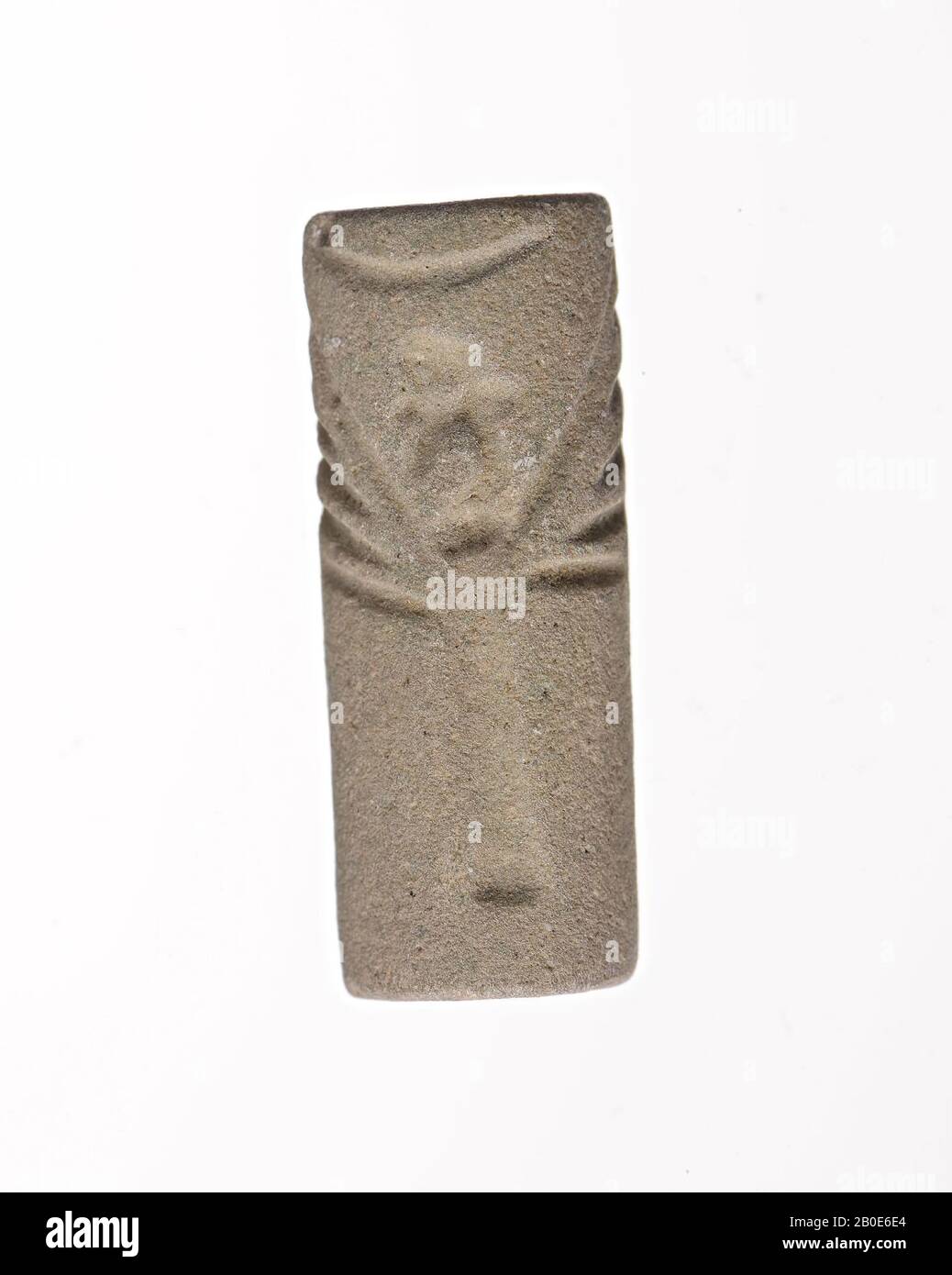 A stone cylinder seal with an image of a standing, winged figure and a ...