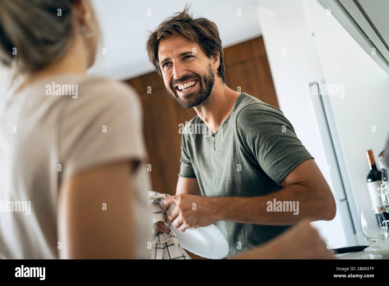 Smiling man cleaning kitchen hi-res stock photography and images - Alamy