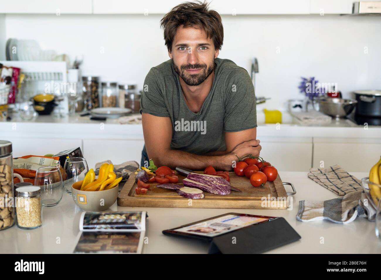 Young man in kitchen with arms crossed hi-res stock photography and ...