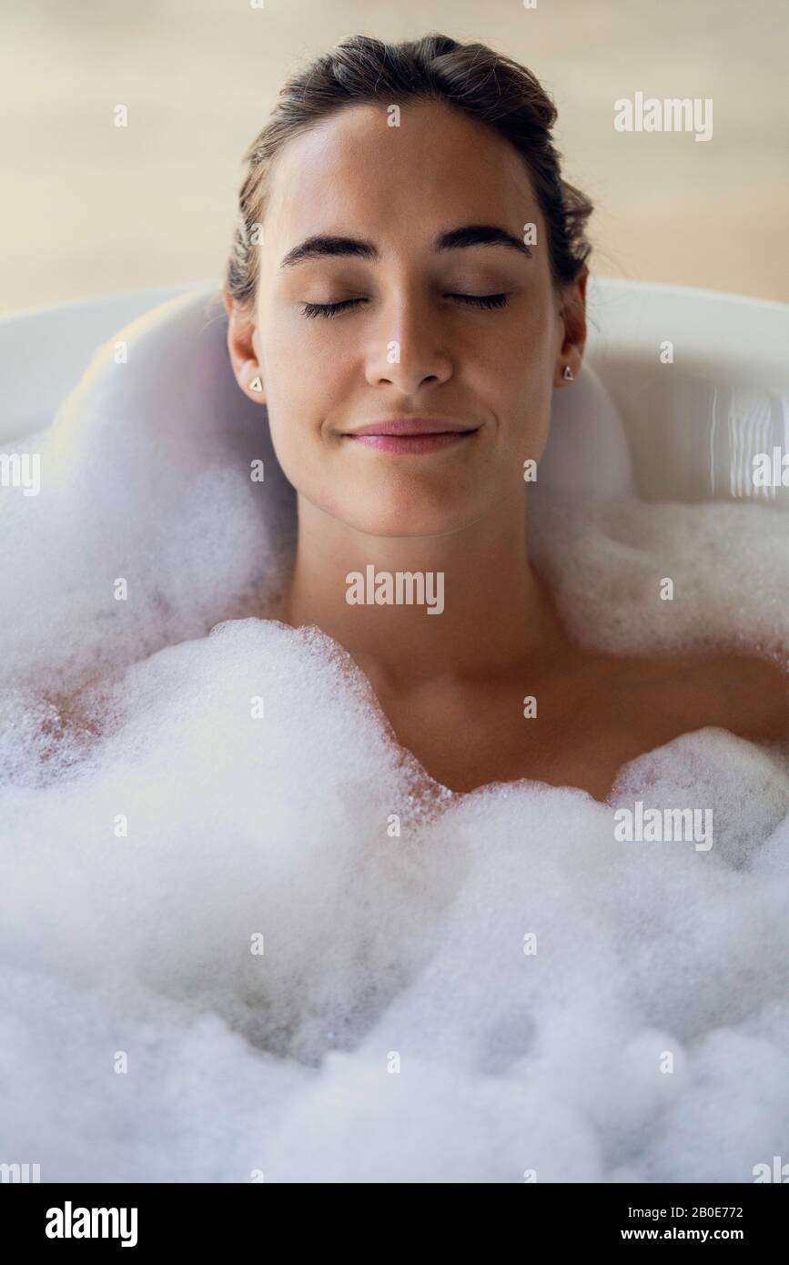Young woman relaxing in bathtub Stock Photo - Alamy