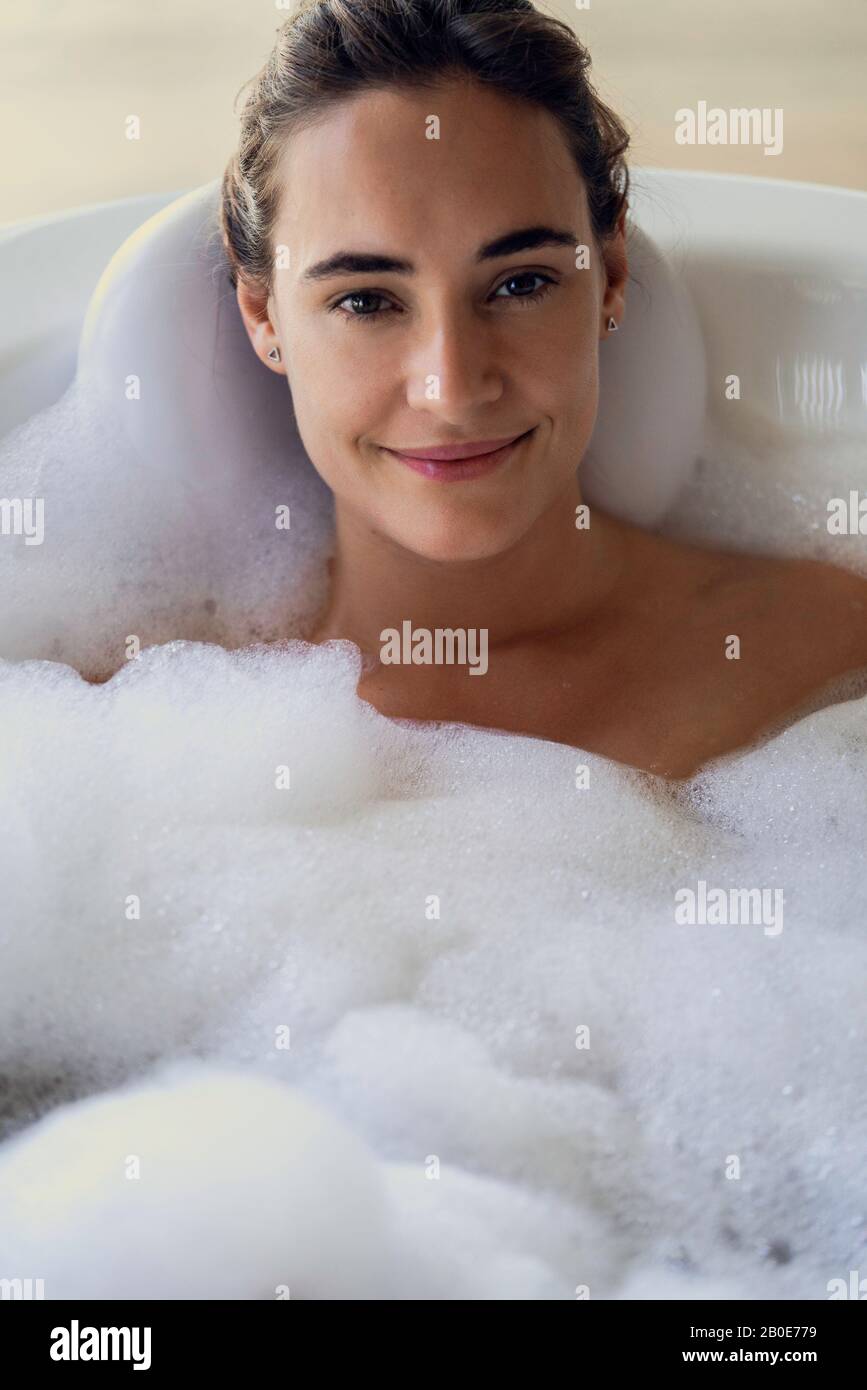 Young woman relaxing in bathtub Stock Photo - Alamy