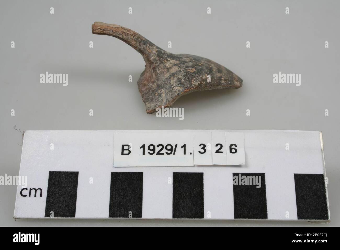 A wall shard with a piece of a vertically running handle. The shard is ...