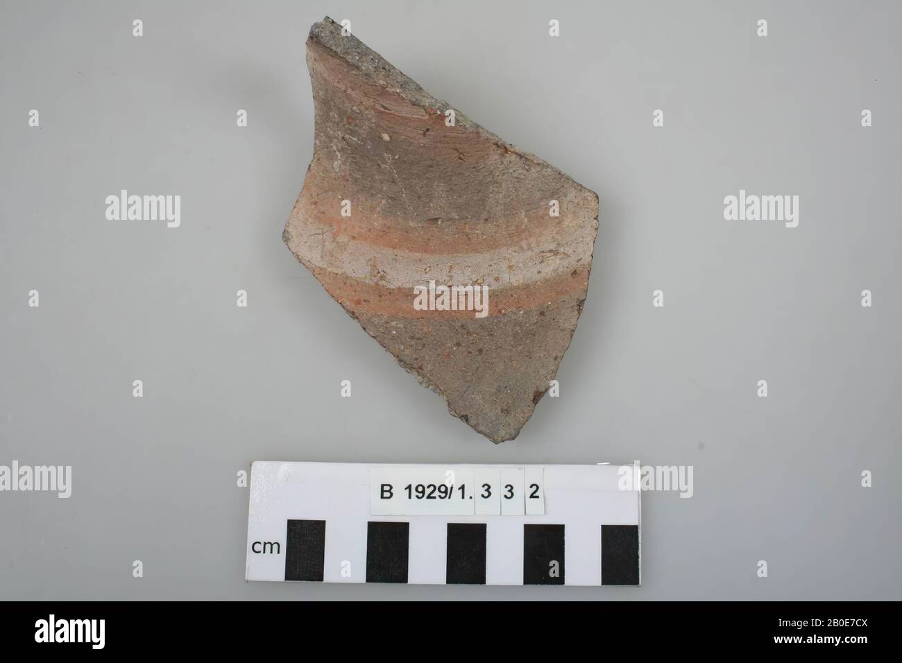 A wall shard of a jug, decorated with red and white, horizontal lines ... A wall shard of a jug, decorated with red and white, horizontal lines ...